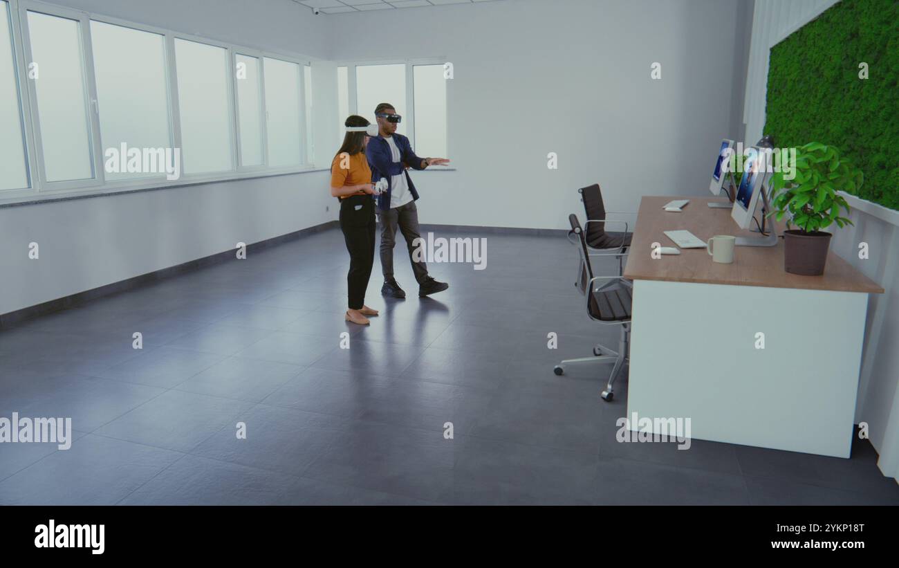 Multiethnic team of two designers using app on tablet computer to ...