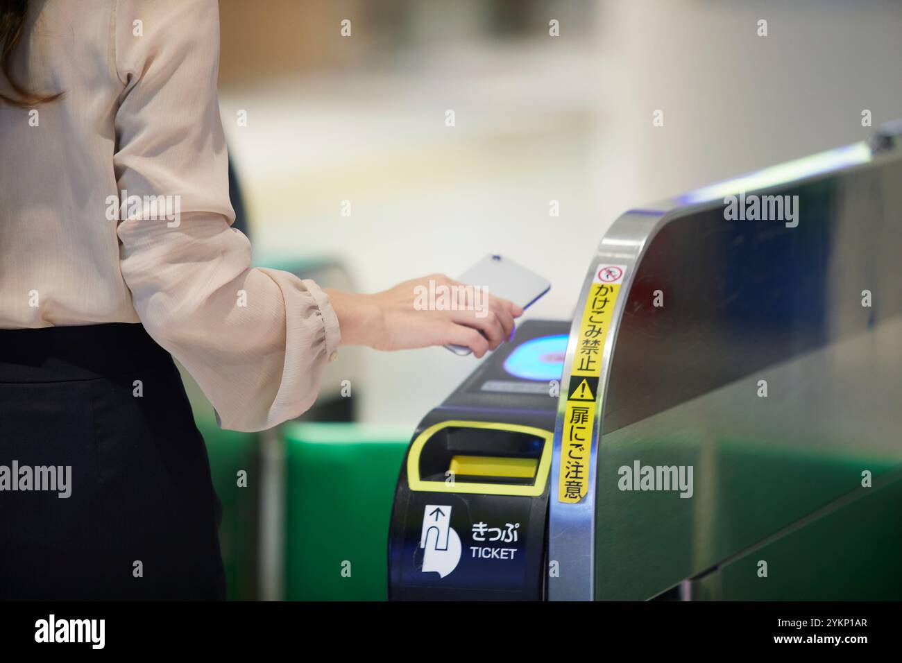 Woman's hand through ticket gate Stock Photo - Alamy