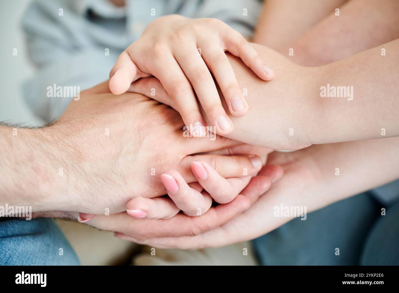 Cute family putting stacked hands together promising help and support ...