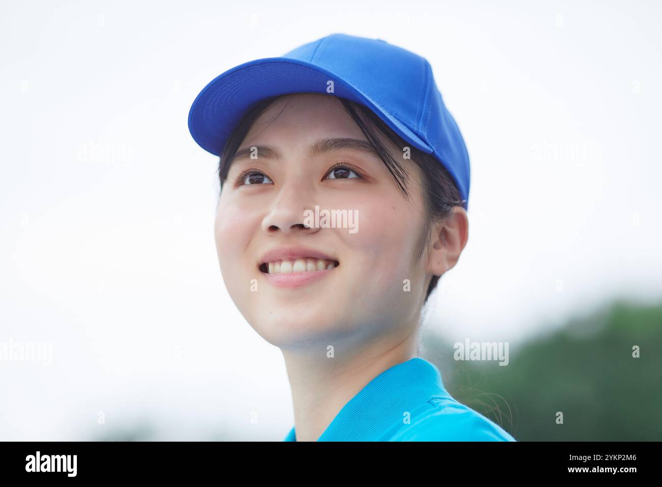 Smiling young woman in work clothes Stock Photo - Alamy
