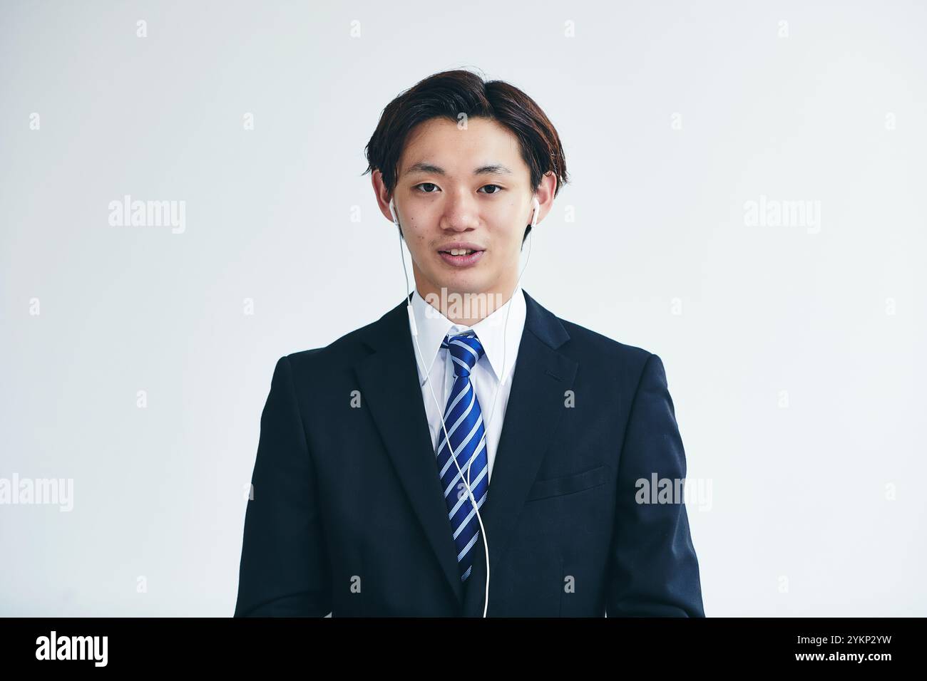 Young man in suit speaking to camera Stock Photo - Alamy