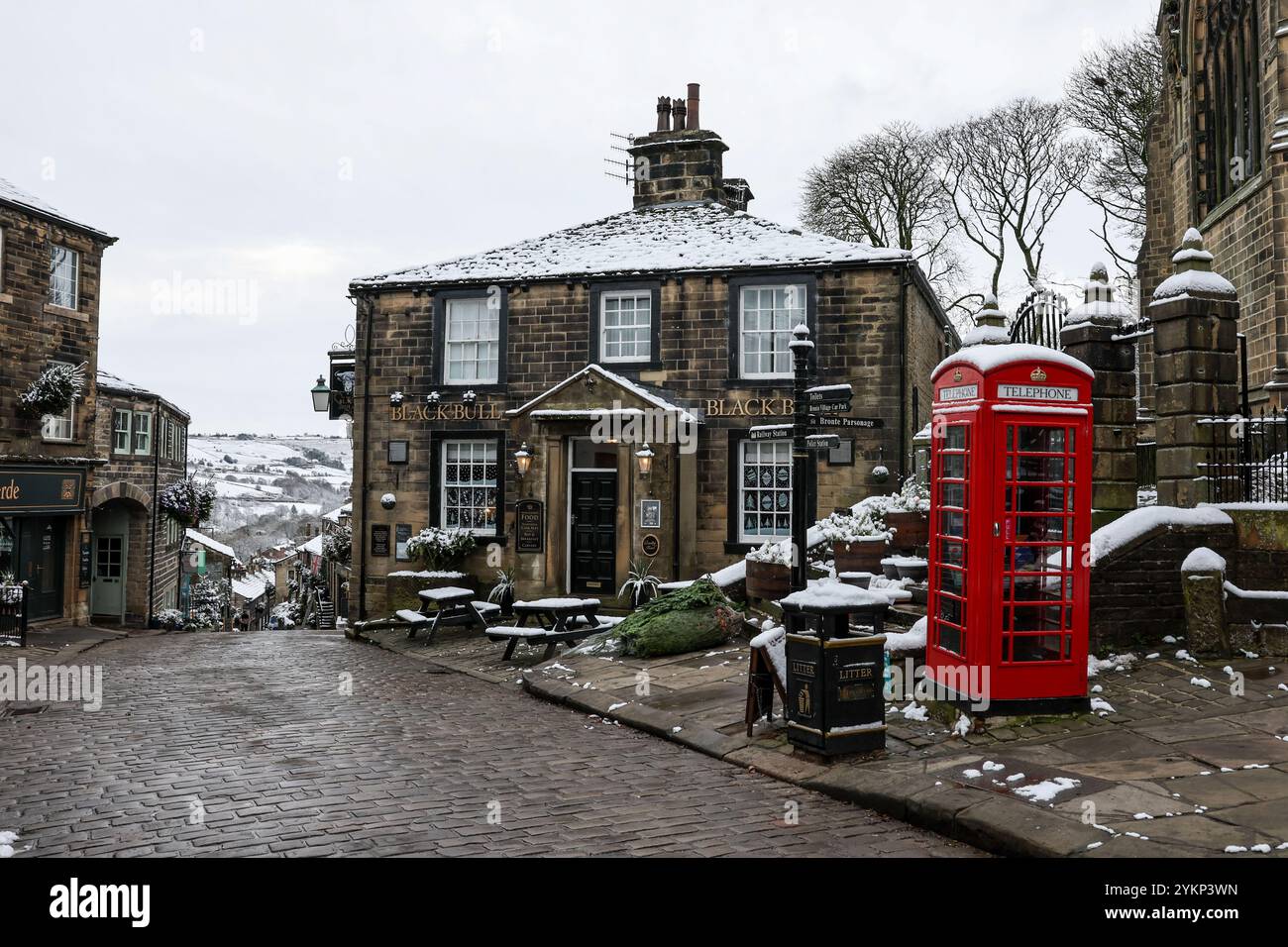 Snow falls in the square near the Black Bull pub in Haworth also know ...