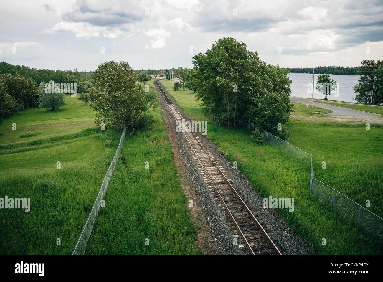 A drone's aerial shot showcases train tracks winding through lush ...
