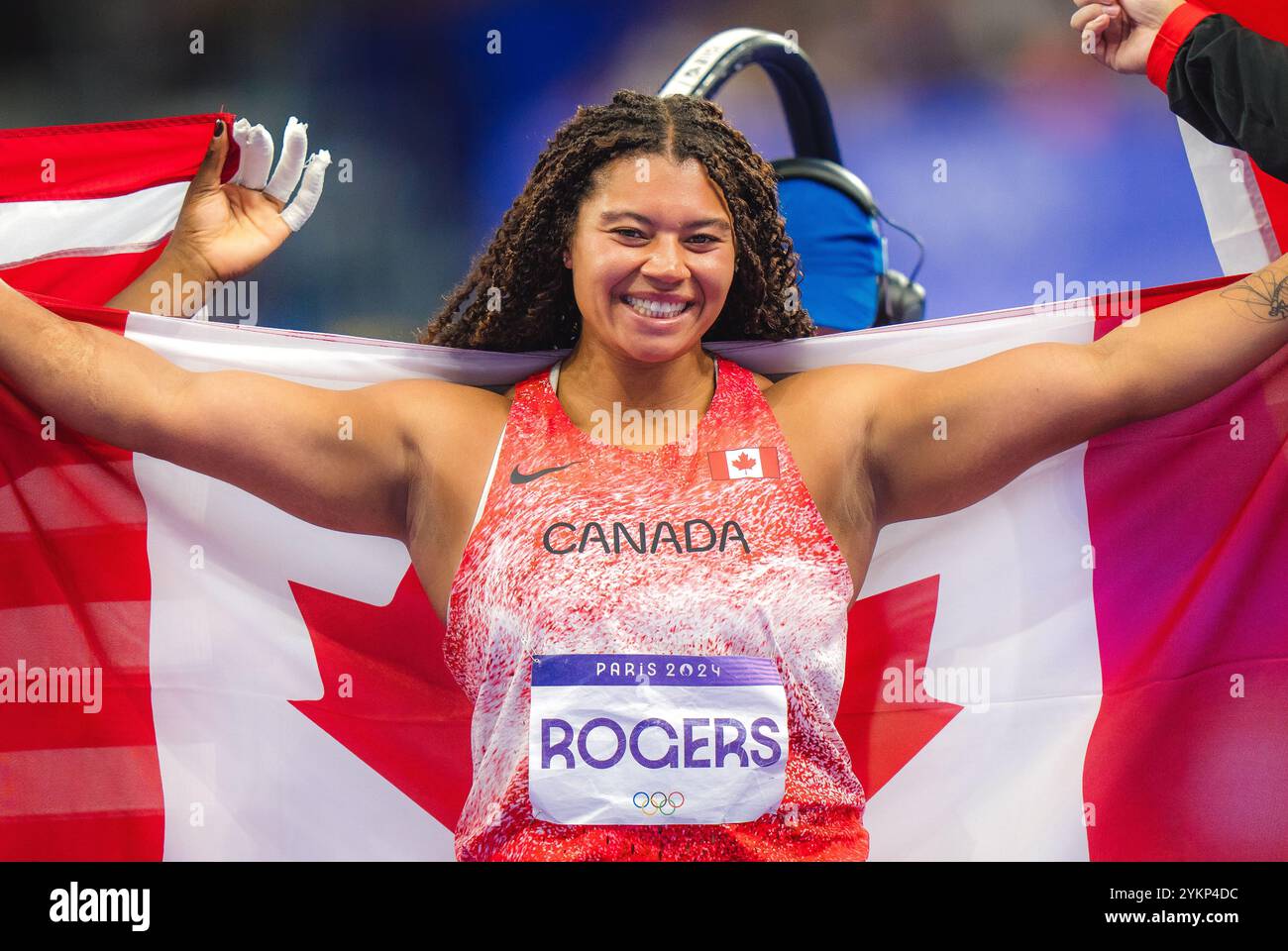 Camryn Rogers celebrating her medal with her country's flag at the ...