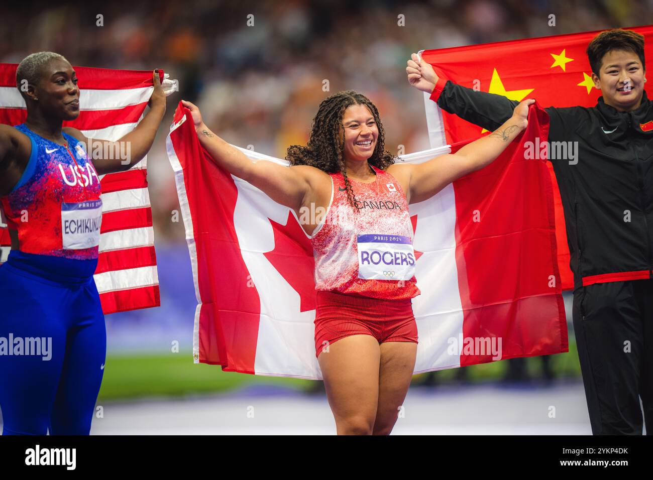Camryn Rogers celebrating her medal with her country's flag at the ...