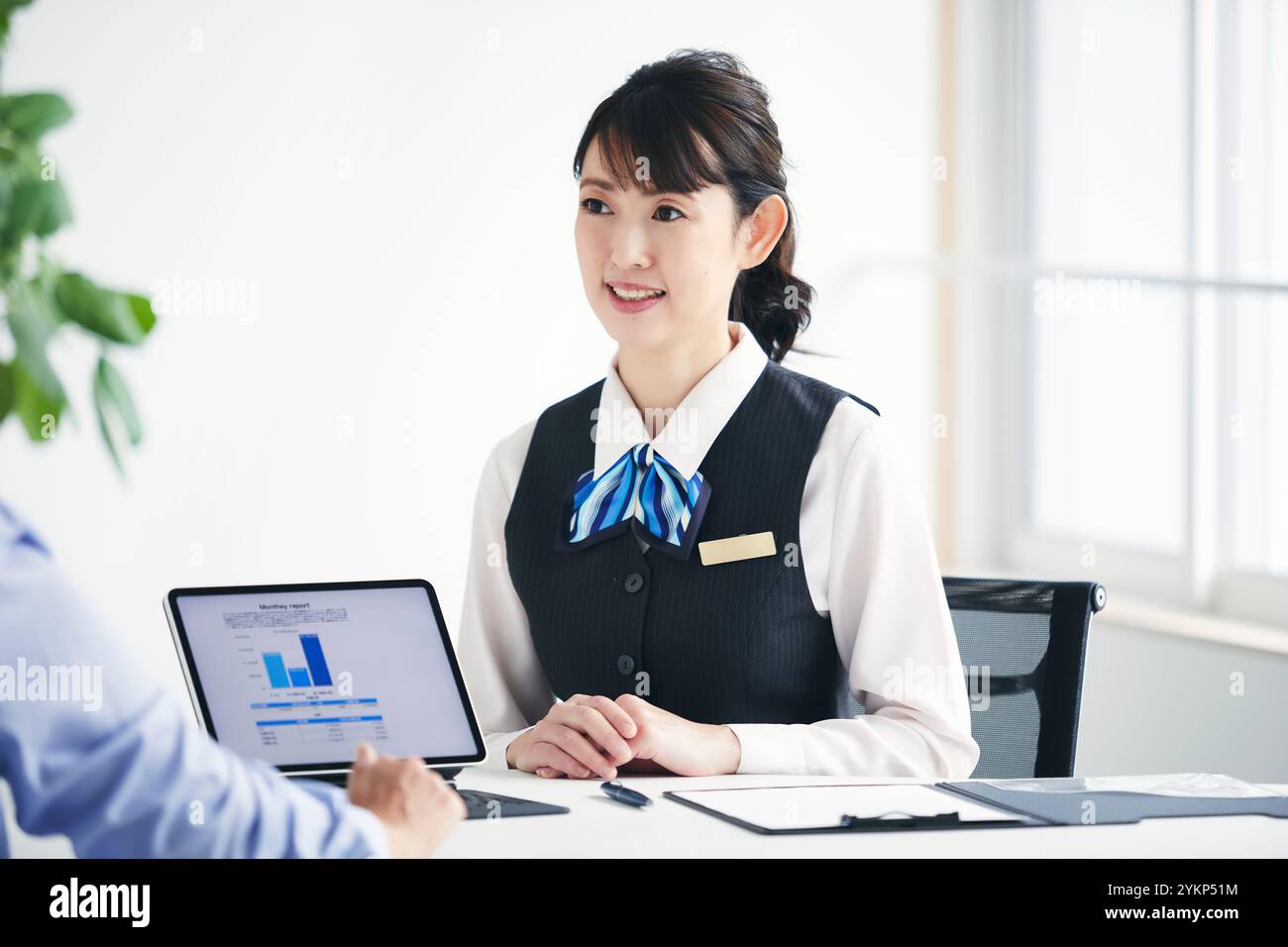 Woman in uniform explaining using a tablet device Stock Photo - Alamy