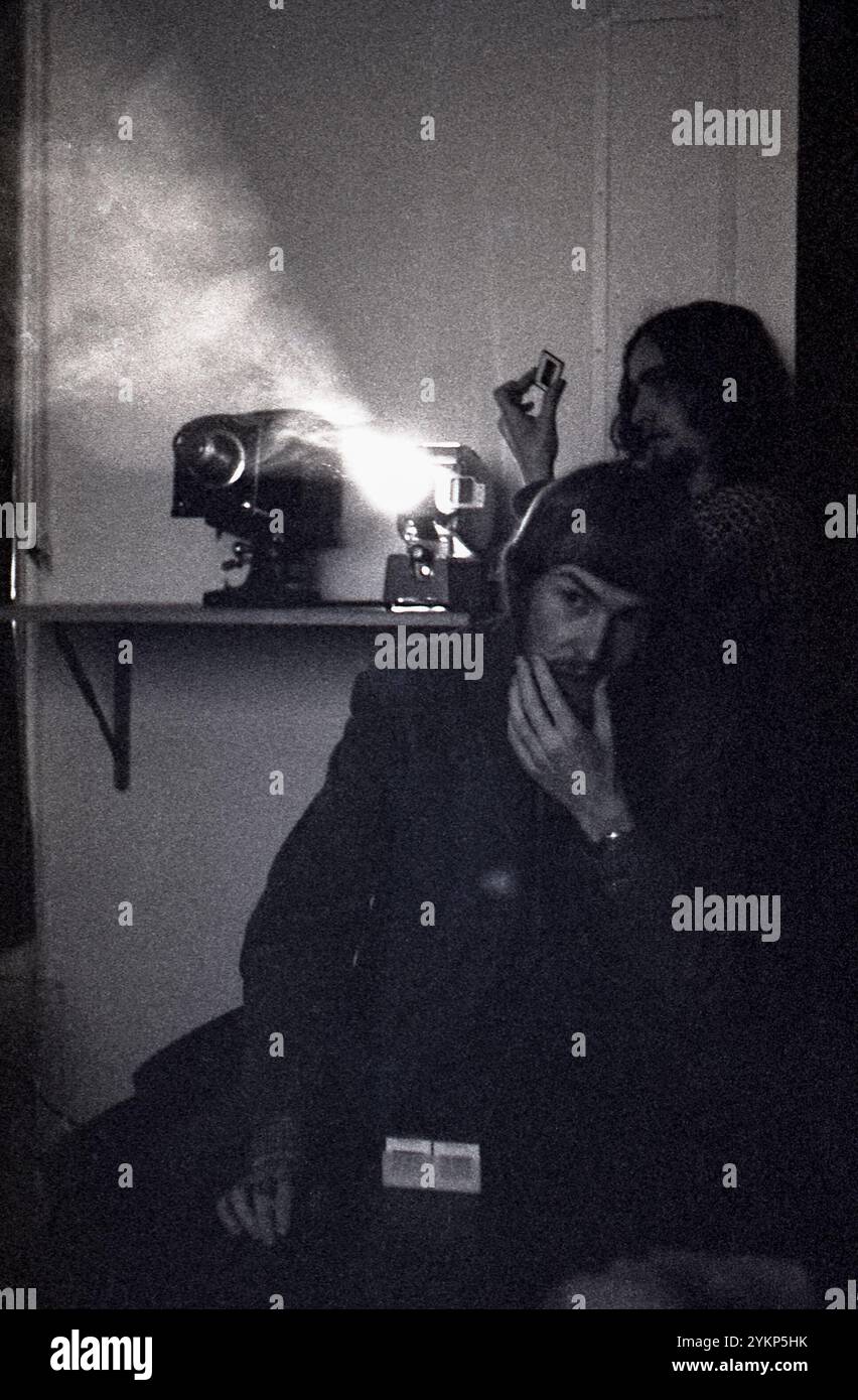 Sharing a slide show, London, 1970 Stock Photo - Alamy