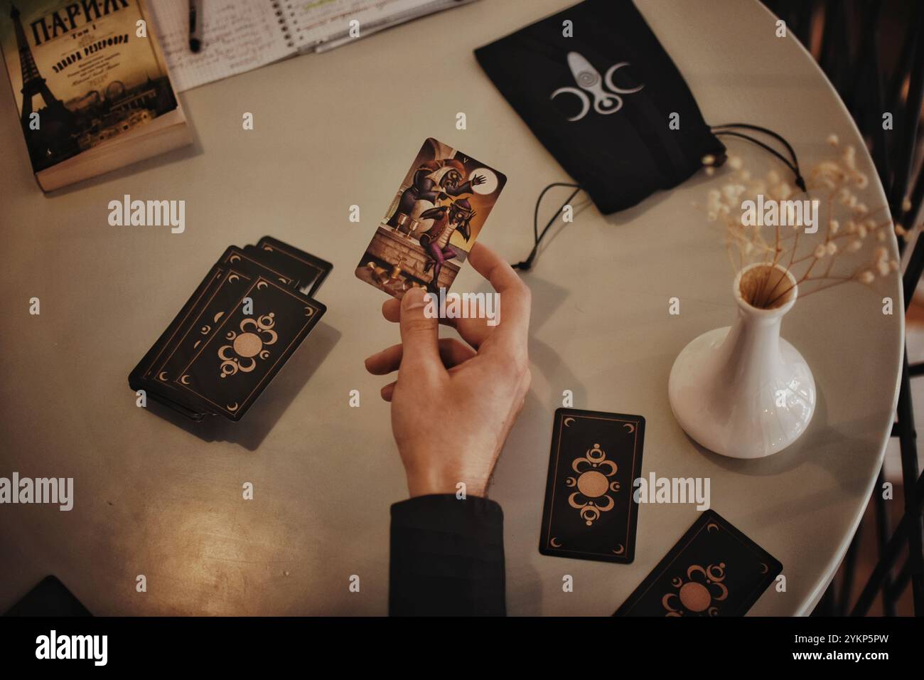 Artistic tarot cards from the Deviant Moon deck held in hands ...