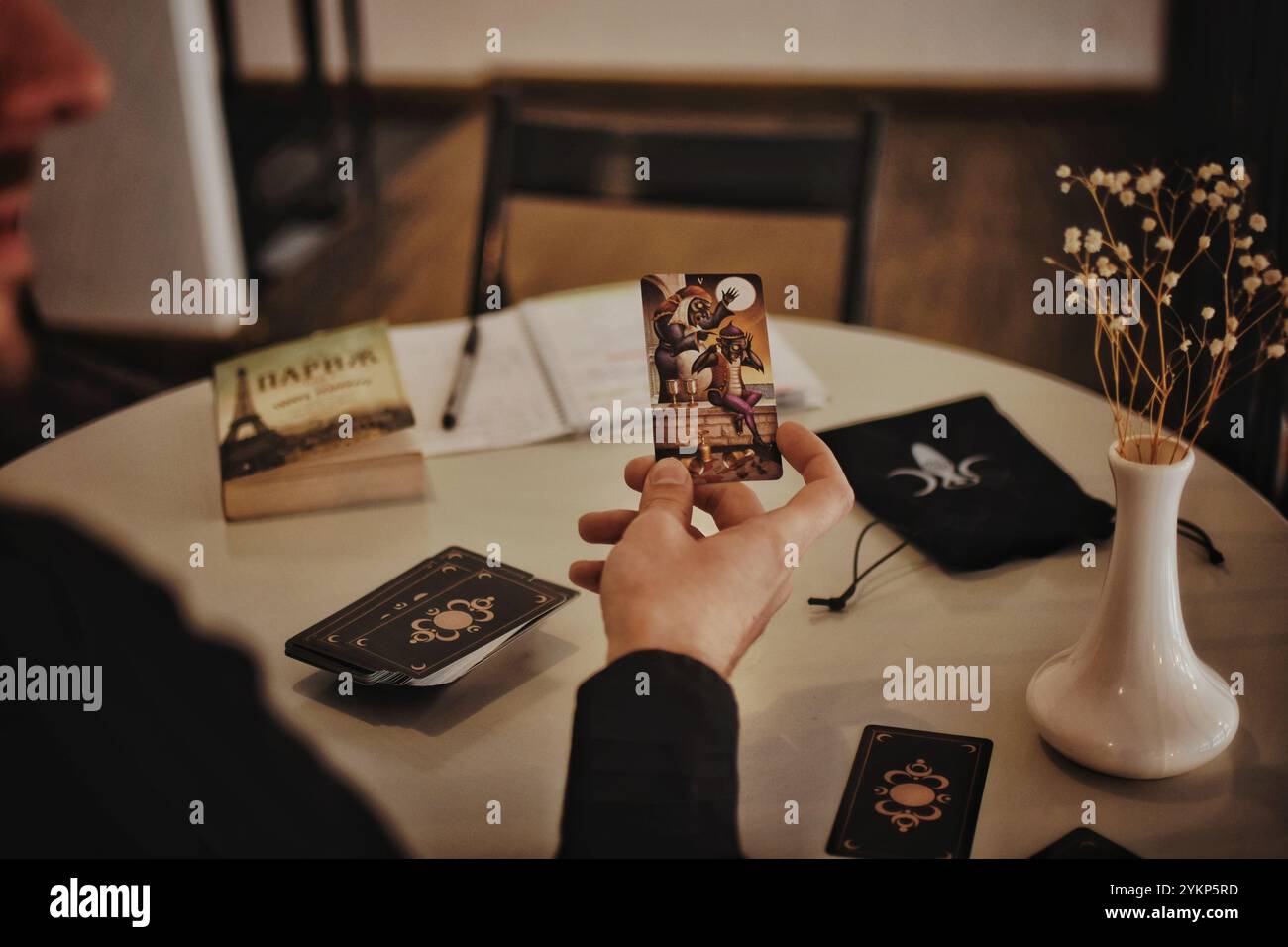 Artistic tarot cards from the Deviant Moon deck held in hands ...