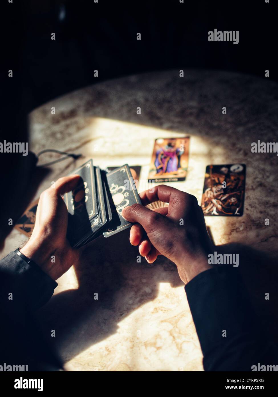 Artistic tarot cards from the Deviant Moon deck held in hands ...