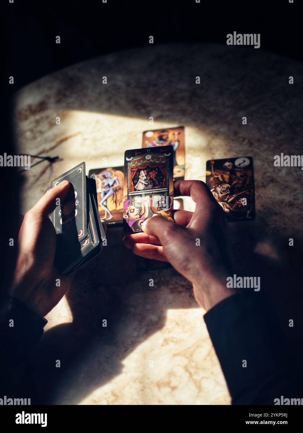 Artistic tarot cards from the Deviant Moon deck held in hands ...