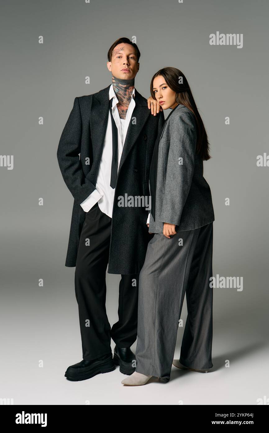 A fashionable duo displays contemporary attire in a sleek studio ...