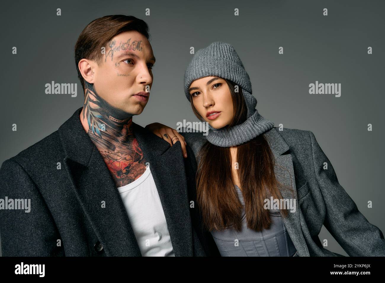 A stylish young couple showcases their unique fashion in a casual ...