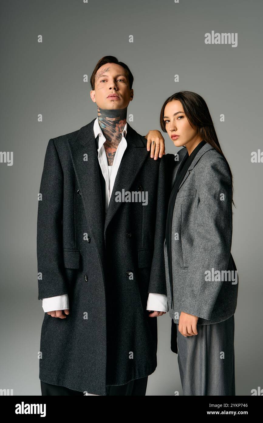 A young attractive couple showcases their fashionable looks in a sleek studio environment Stock ...