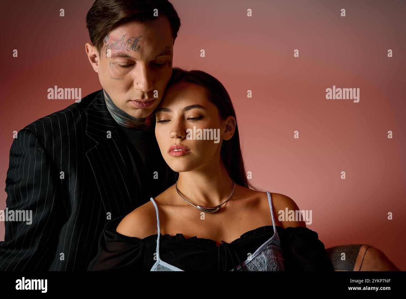 A young couple stands closely, sharing an intimate moment with a dreamy ...