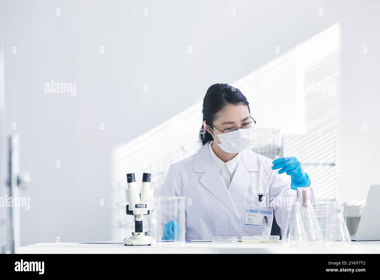 Female researcher in white coat doing research Stock Photo - Alamy
