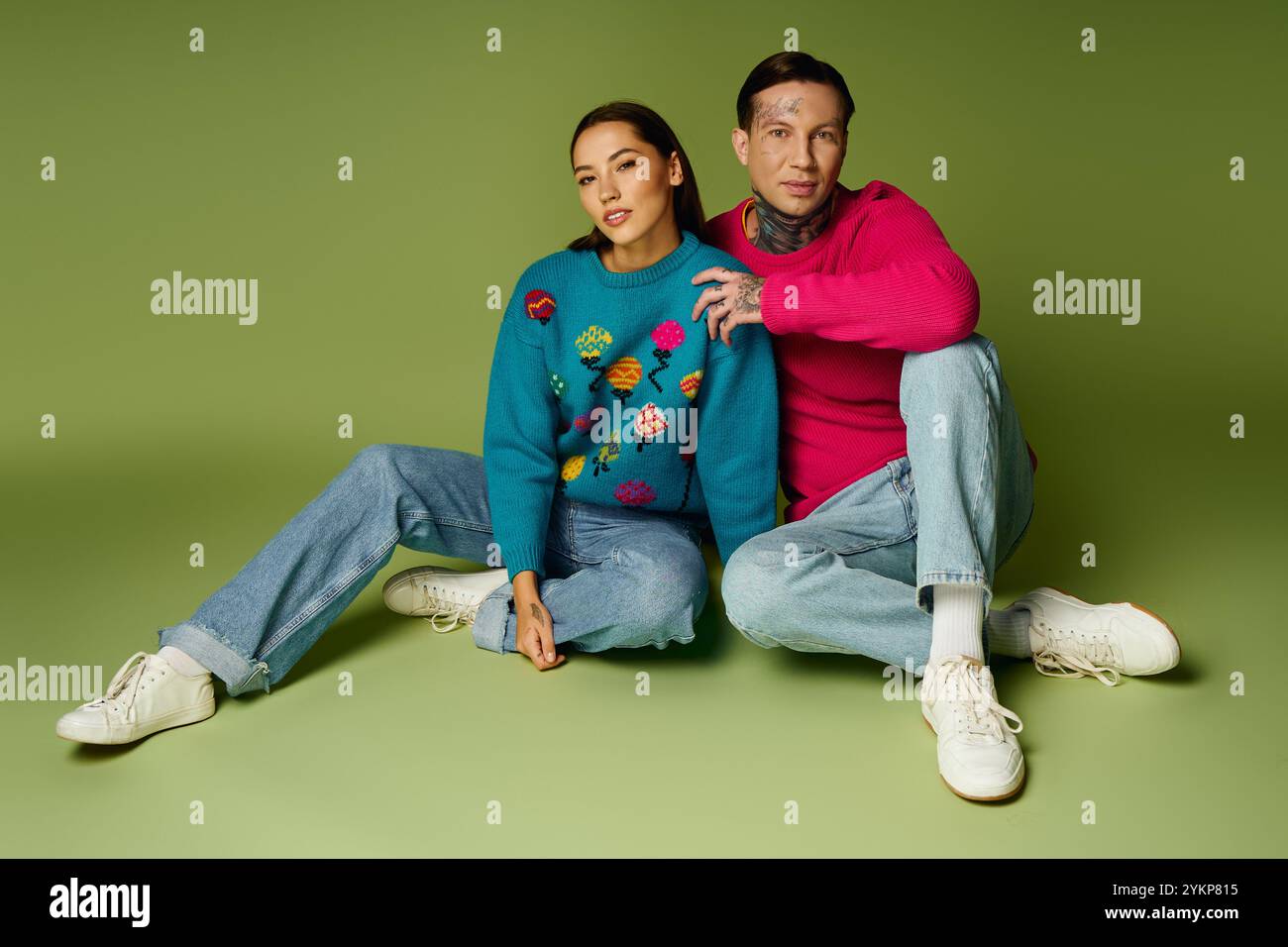 Stylish duo poses together on the floor, highlighting their unique ...