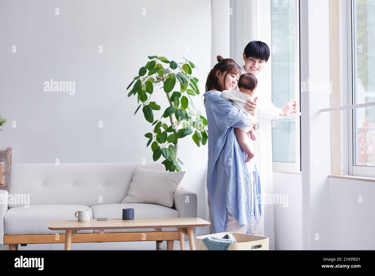 Three parents and their children relaxing in the living room Stock ...