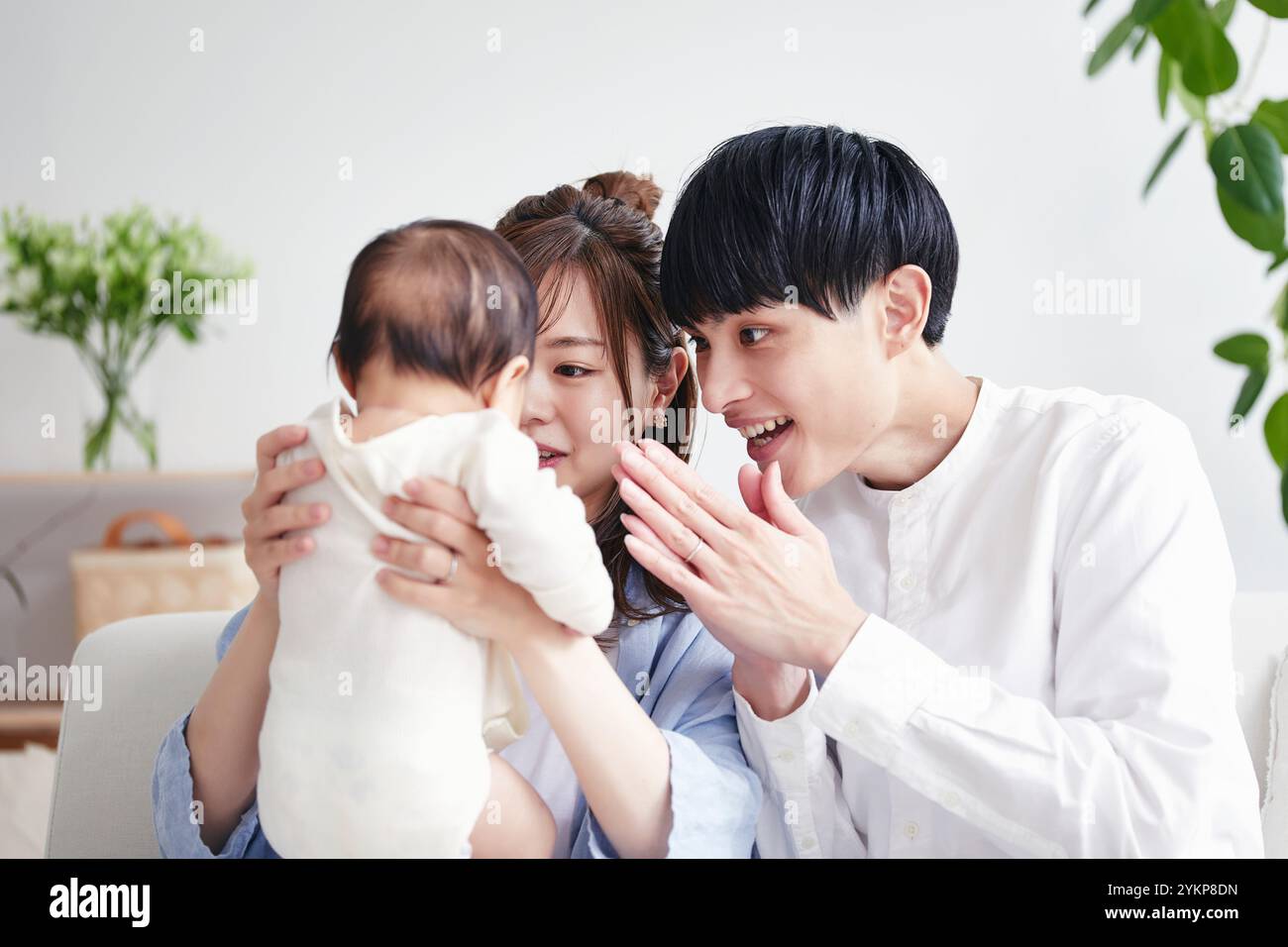 Three parents and their children relaxing in the living room Stock ...