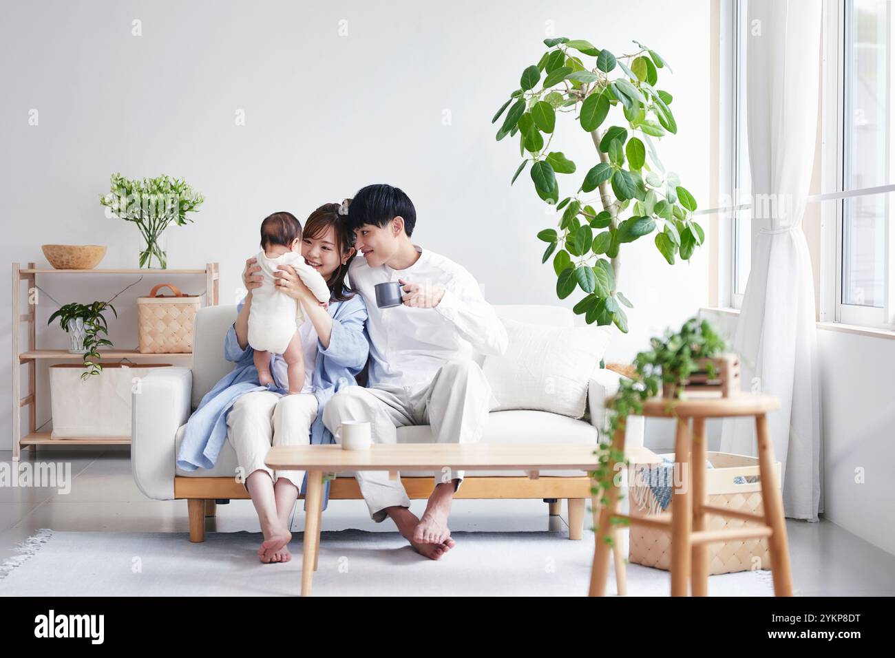 Three parents and their children relaxing in the living room Stock ...