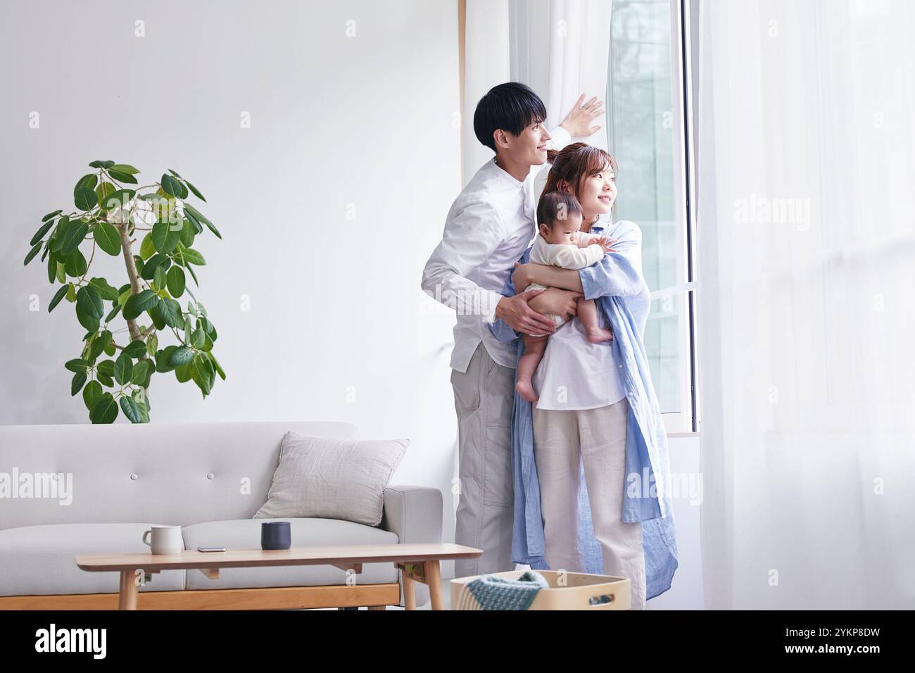 Three parents and their children relaxing in the living room Stock ...