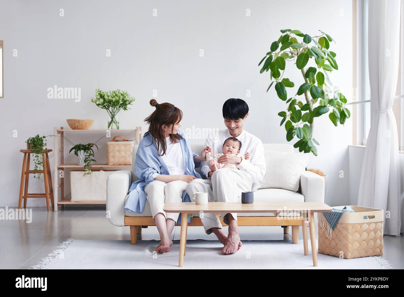 Three parents and their children relaxing in the living room Stock ...