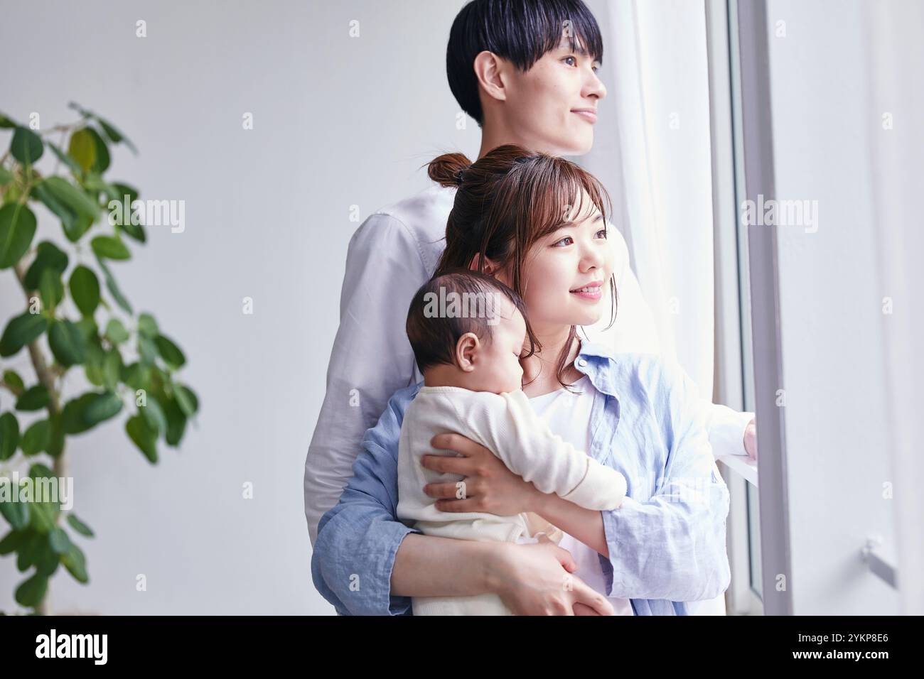 Three parents and their children relaxing in the living room Stock ...