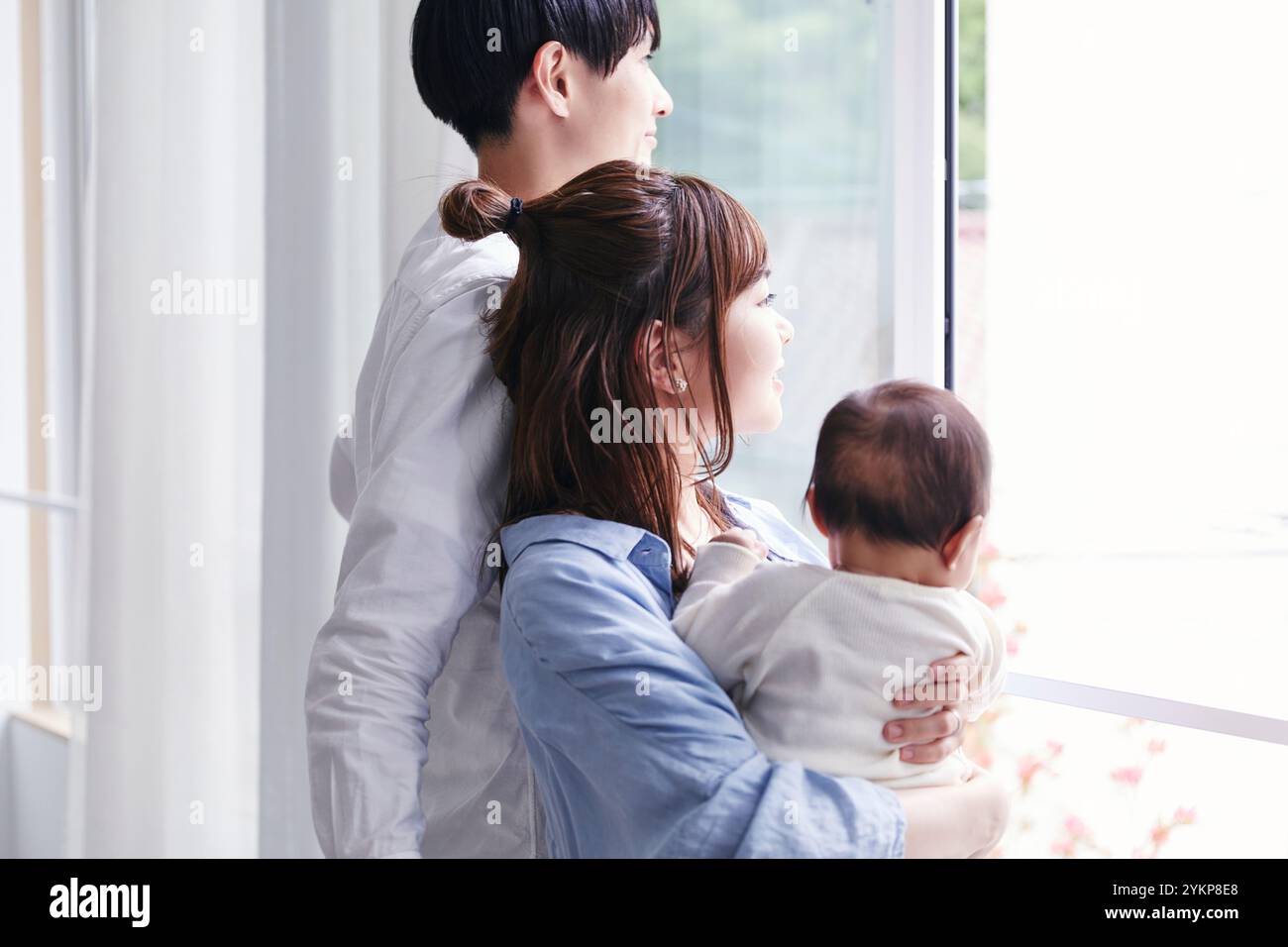 Three parents and their children relaxing in the living room Stock ...
