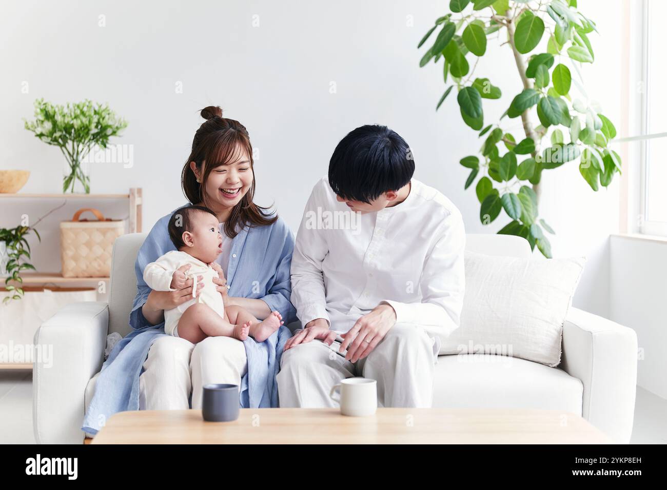 Three parents and their children relaxing in the living room Stock ...