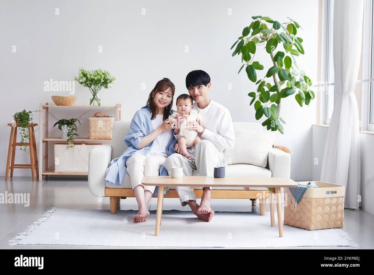 Three parents and their children relaxing in the living room Stock ...