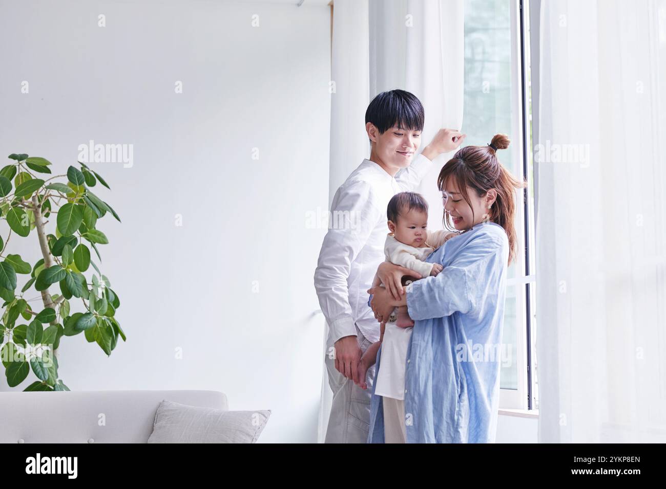 Three parents and their children relaxing in the living room Stock ...