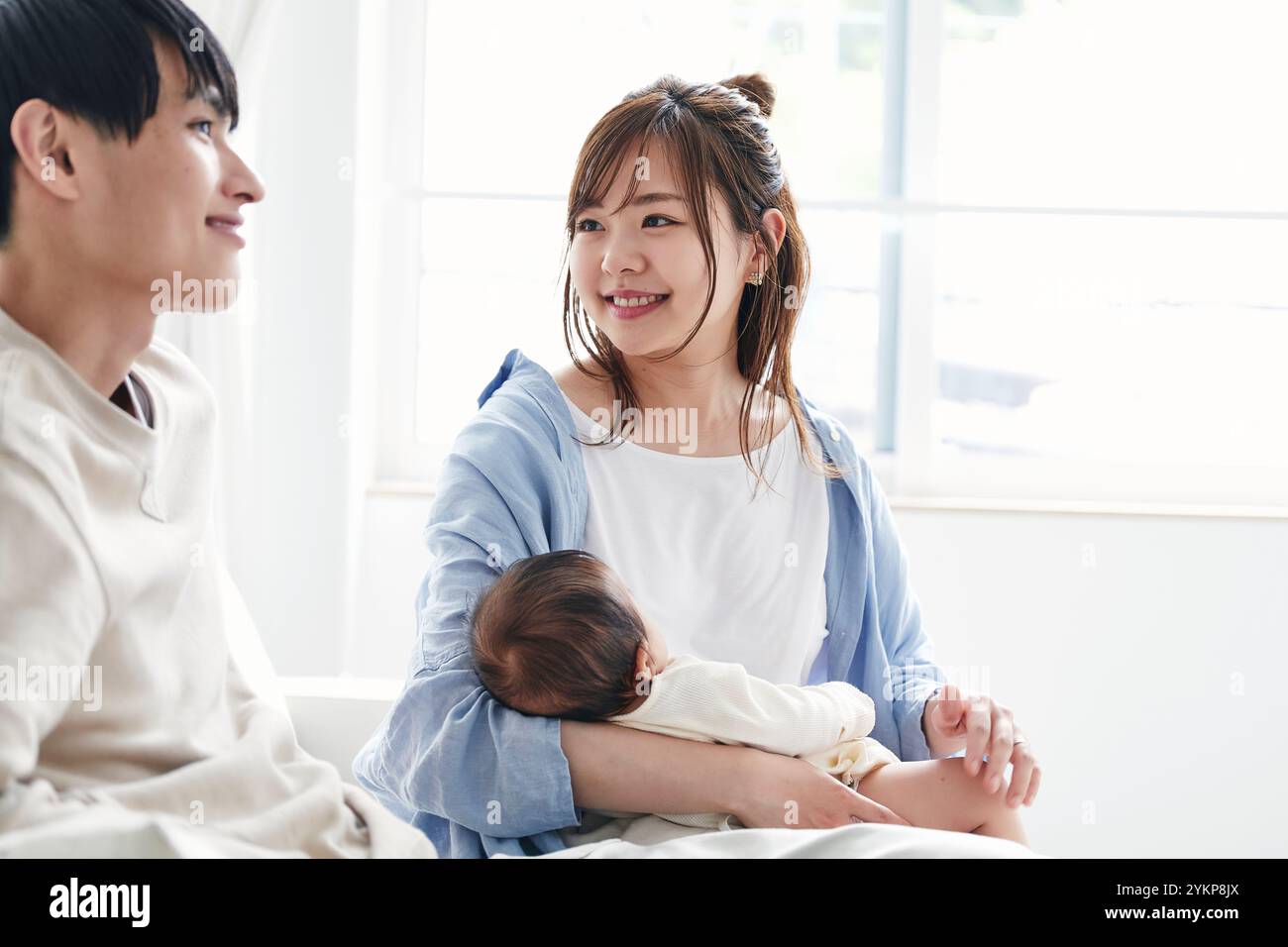 Three parents and their children relaxing in the living room Stock ...
