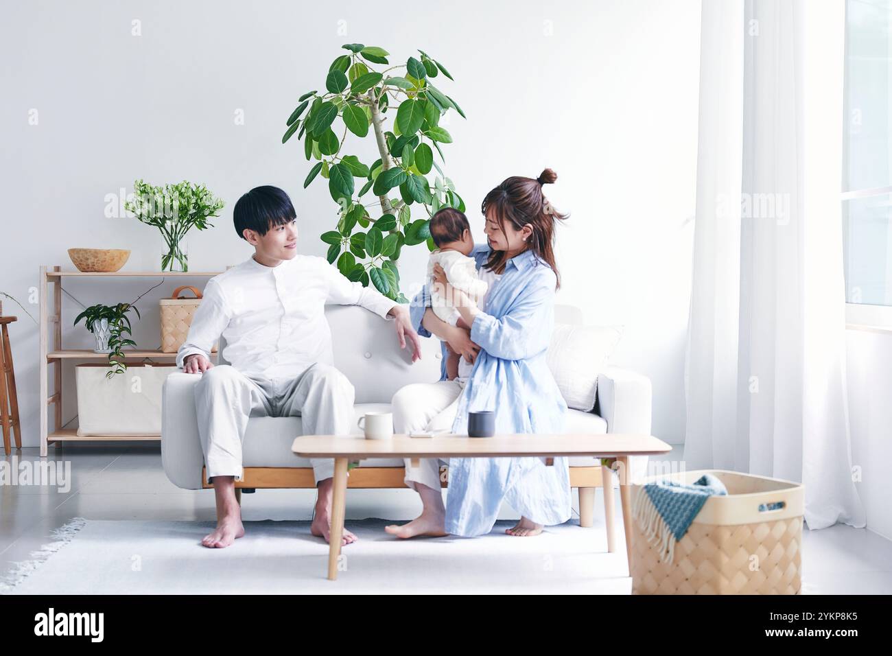 Three parents and their children relaxing in the living room Stock ...