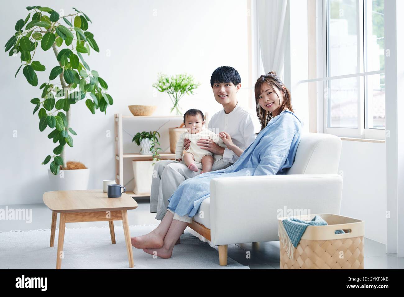 Three parents and their children relaxing in the living room Stock ...