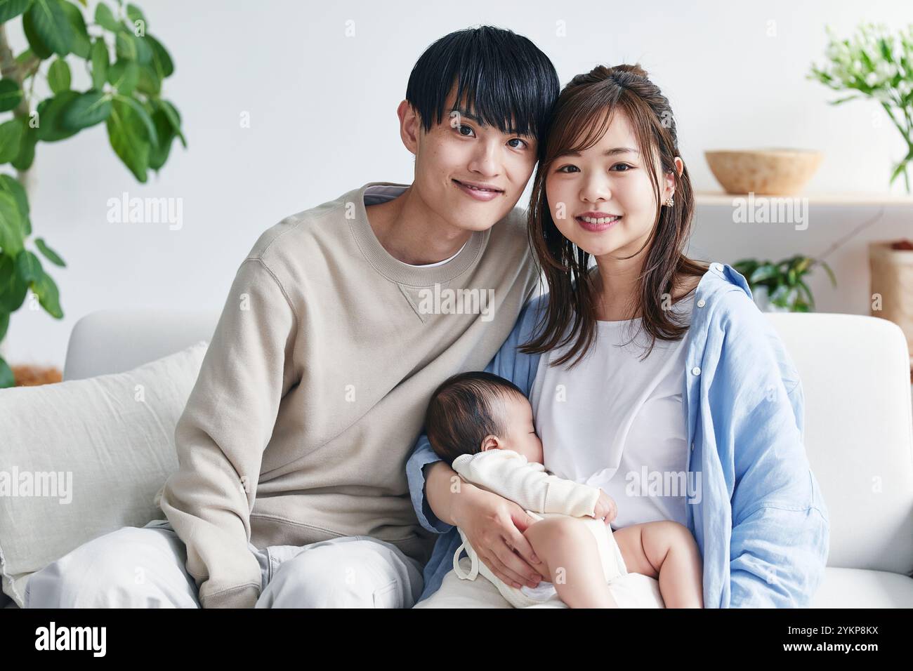 Three parents and their children relaxing in the living room Stock ...
