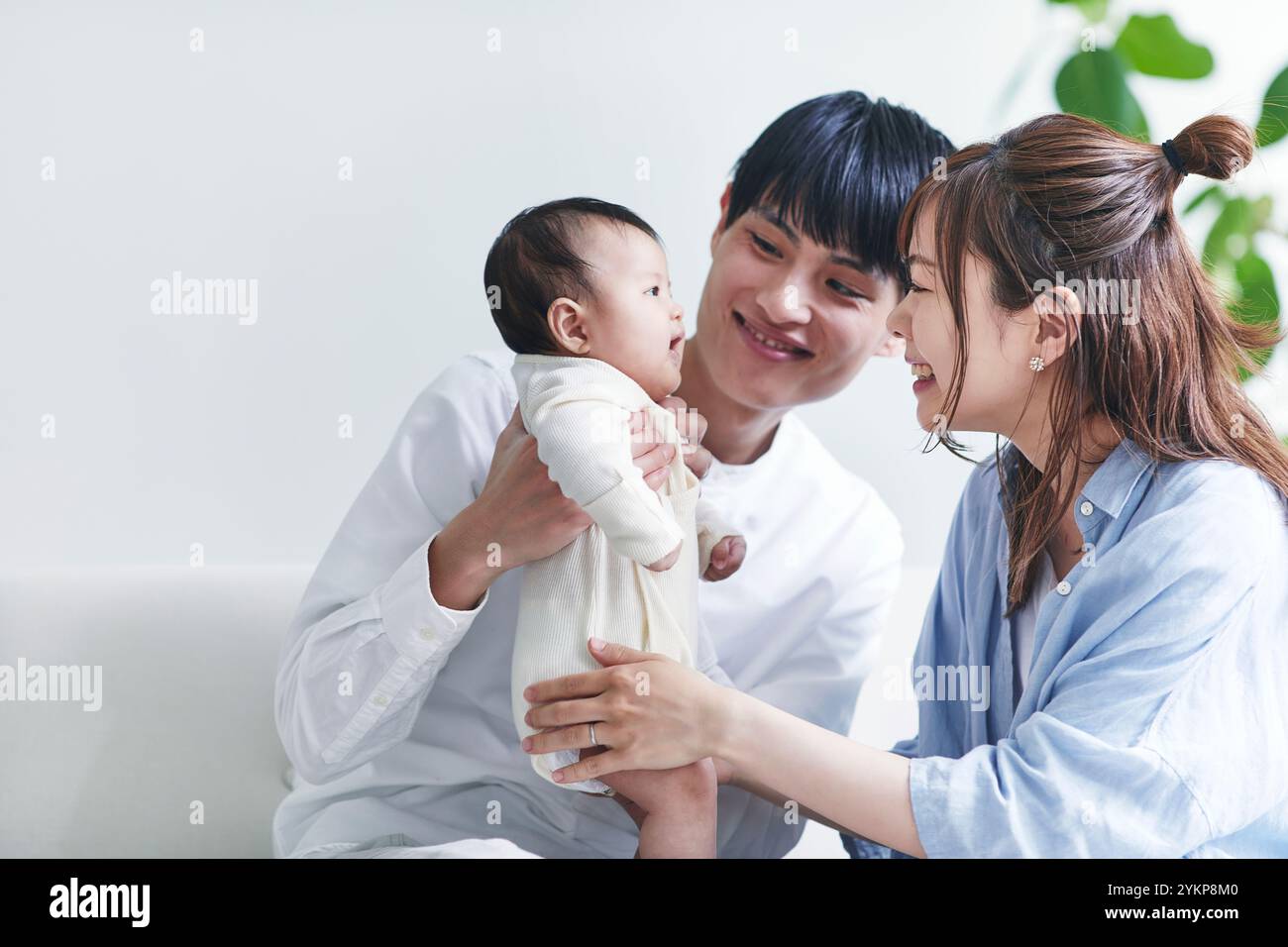 Three parents and their children relaxing in the living room Stock ...