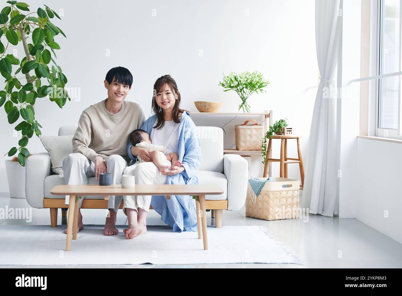 Three parents and their children relaxing in the living room Stock ...