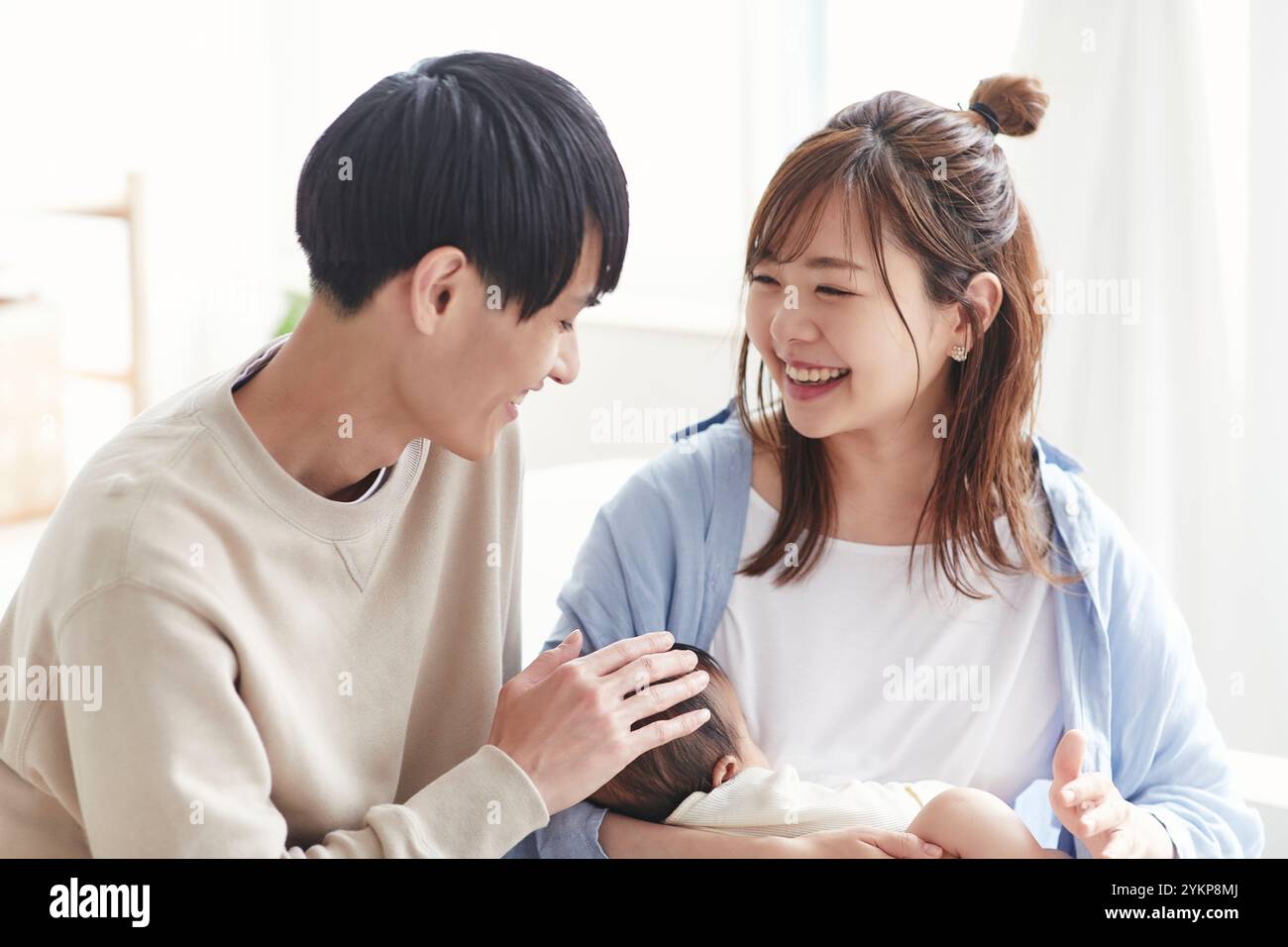 Three parents and their children relaxing in the living room Stock ...