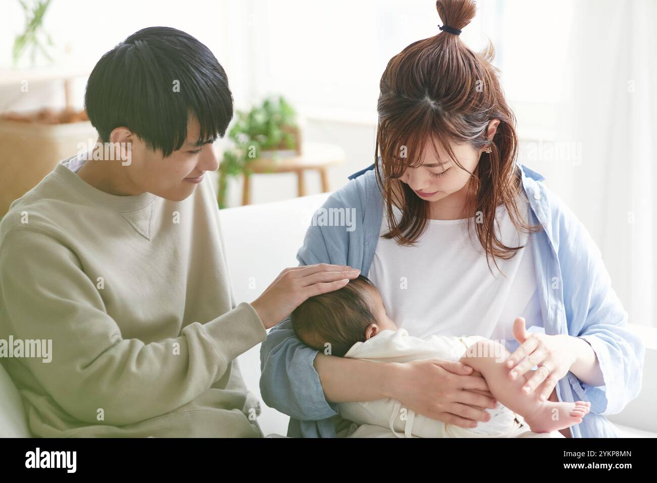 Three parents and their children relaxing in the living room Stock ...
