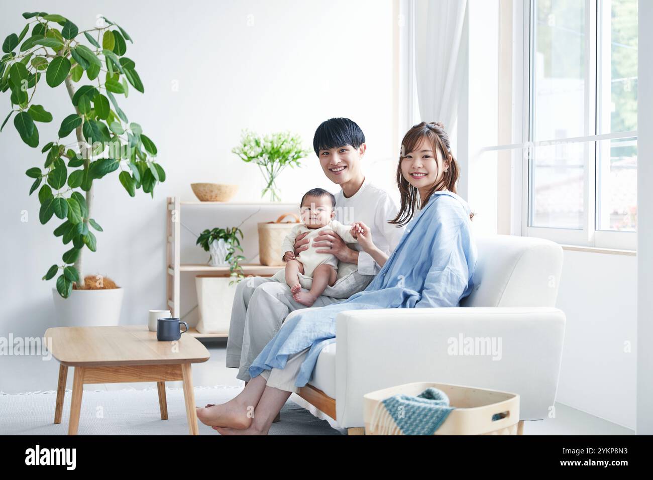 Three parents and their children relaxing in the living room Stock ...