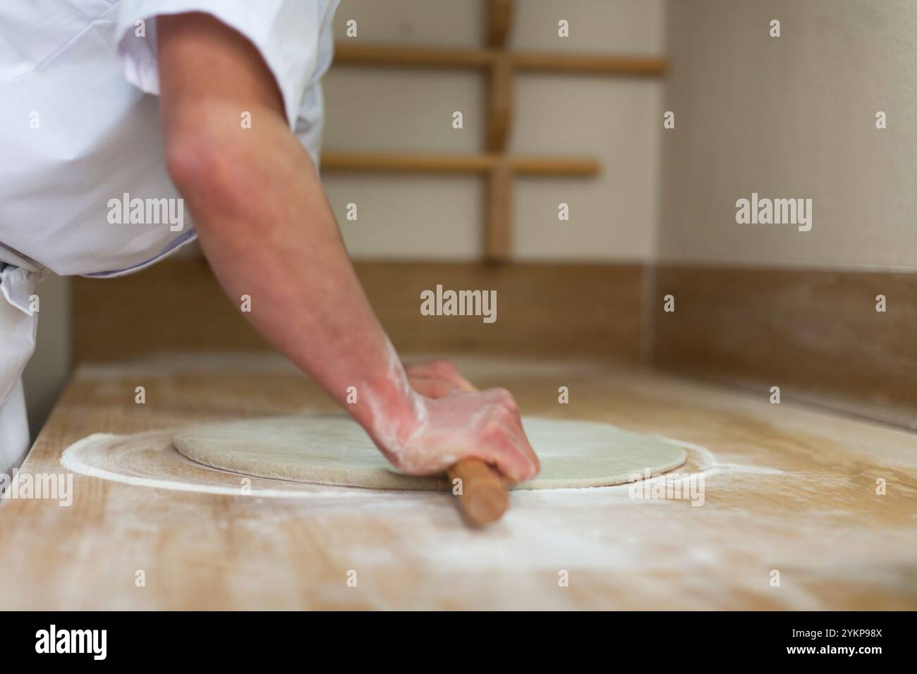 Soba maker's hands holding a rolling pin and beating soba noodles Stock ...