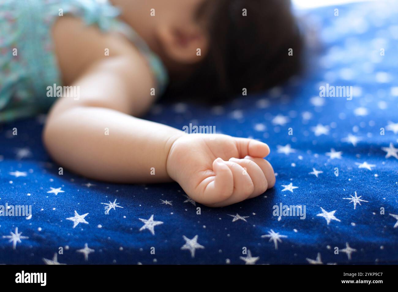 Baby's hands napping in sunny room Stock Photo - Alamy