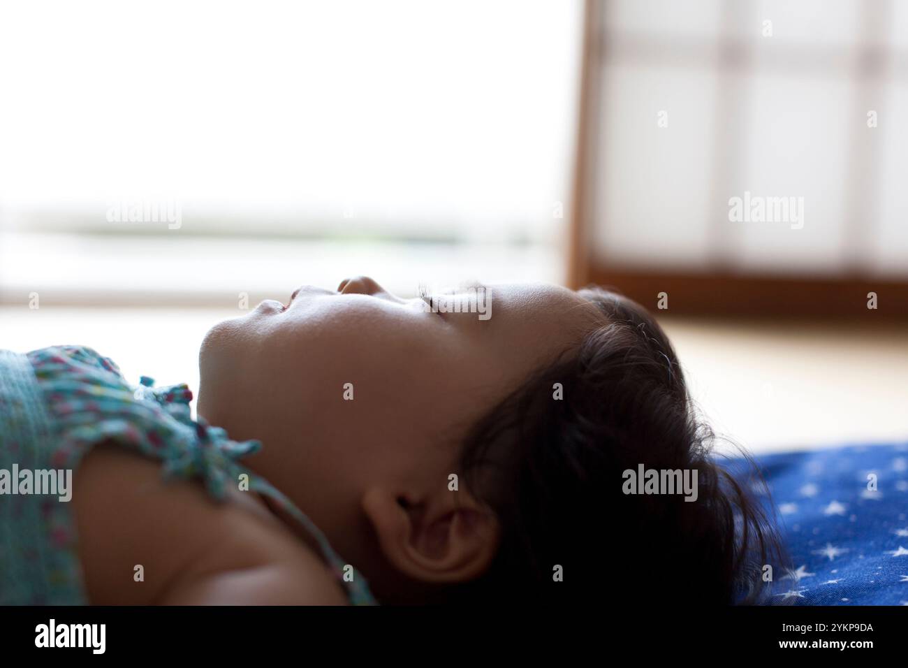 Baby napping in a sunny room in profile Stock Photo - Alamy