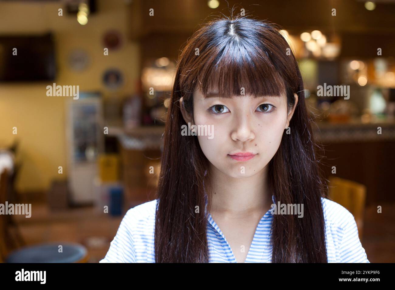 Serious woman looking straight at me Stock Photo - Alamy