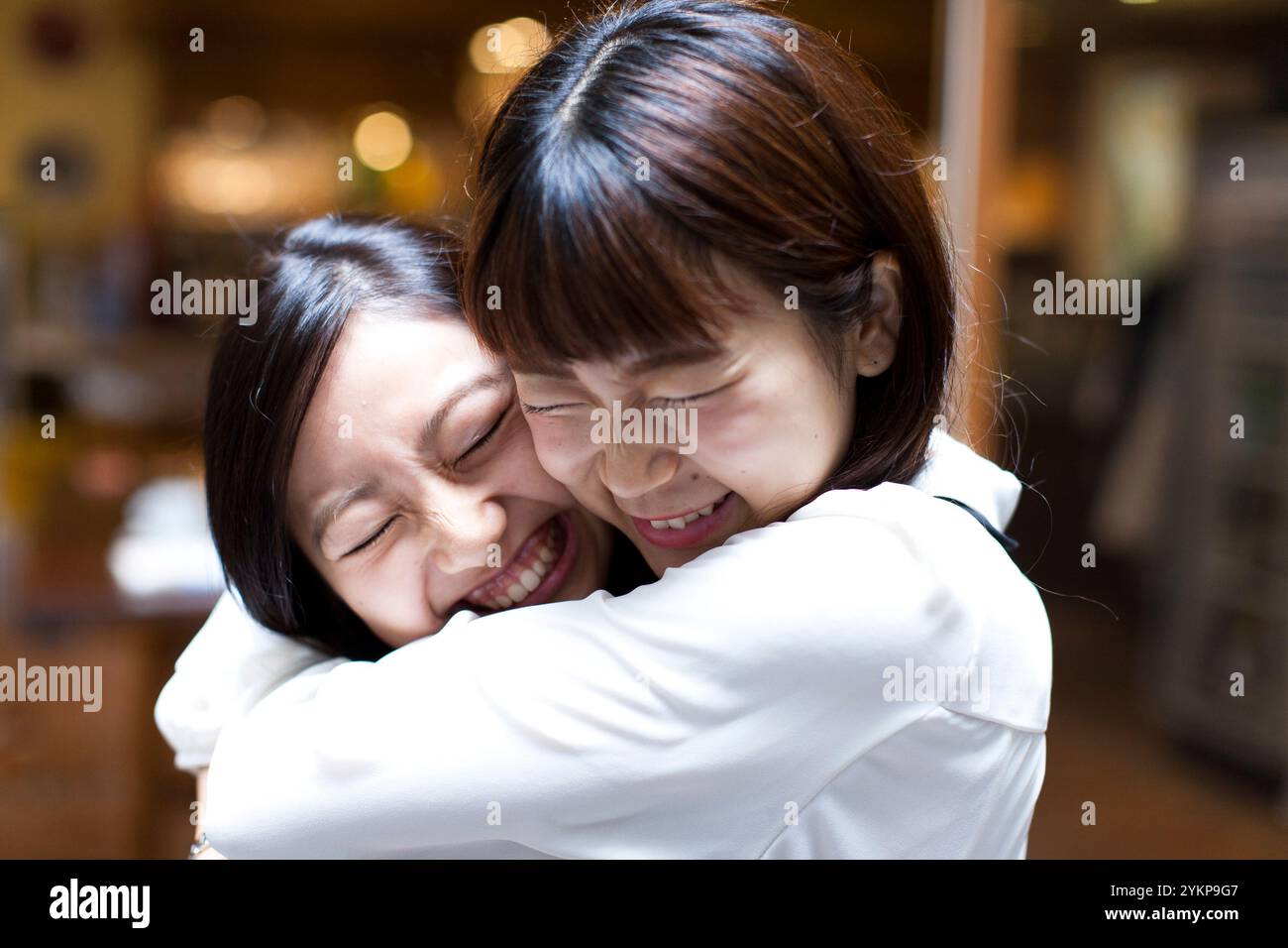Two women embracing and cheek to cheek after a happy occasion Stock ...