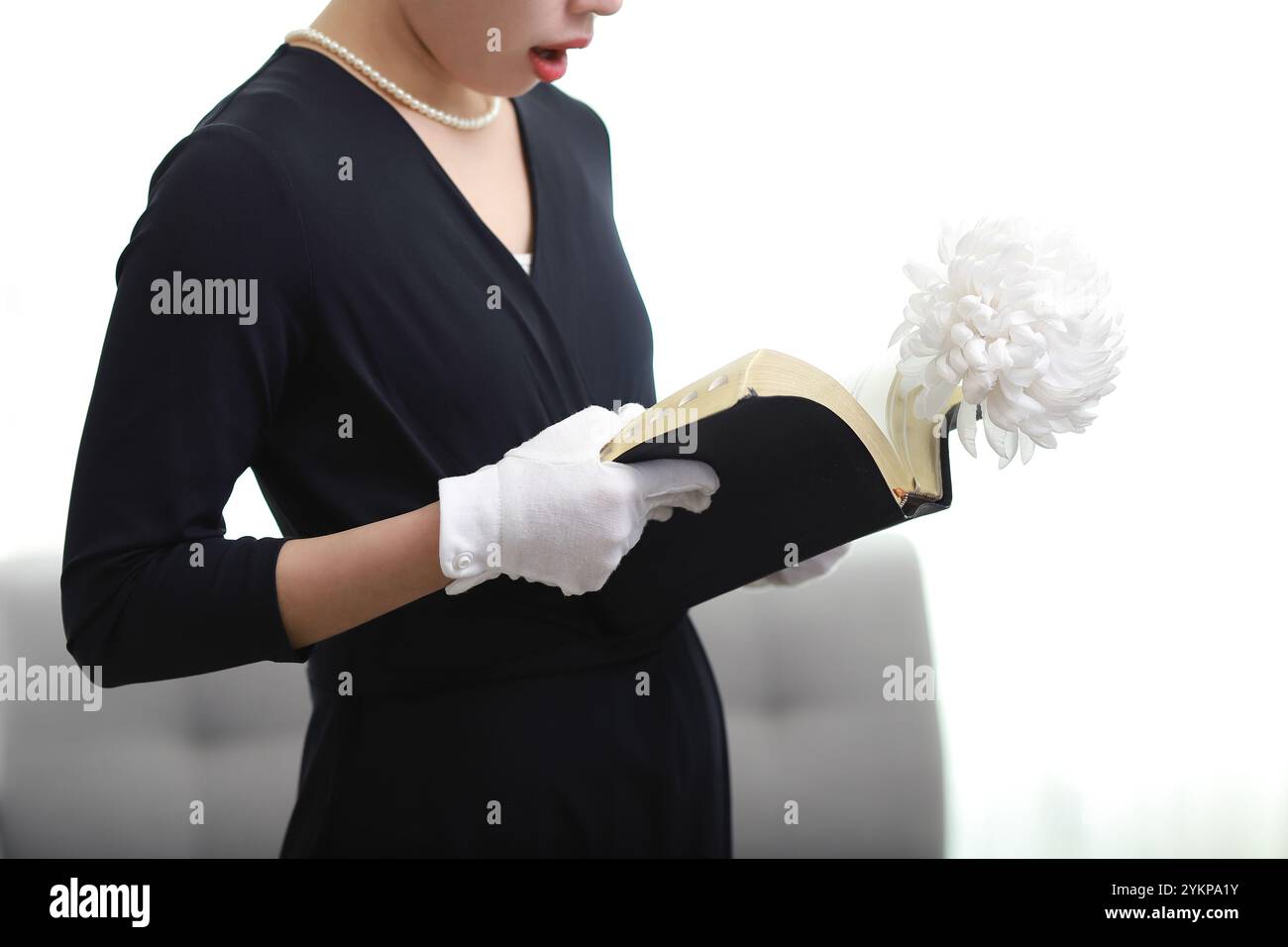 Woman reading Bible at funeral home Stock Photo - Alamy