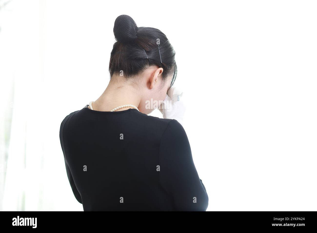 Woman's back view at funeral home Stock Photo - Alamy