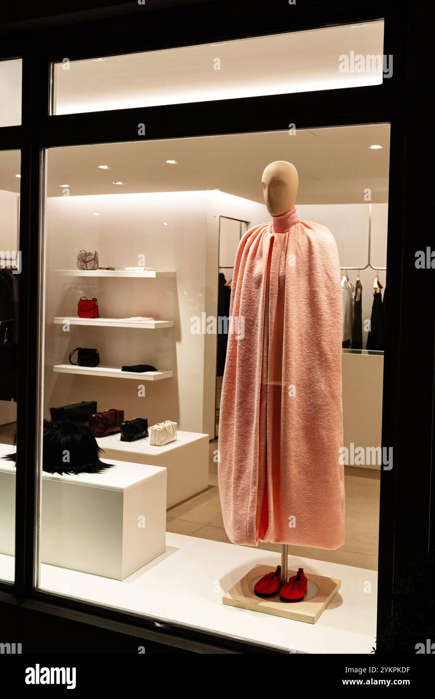 Female mannequin in store glass window display dressed elegant, long ...