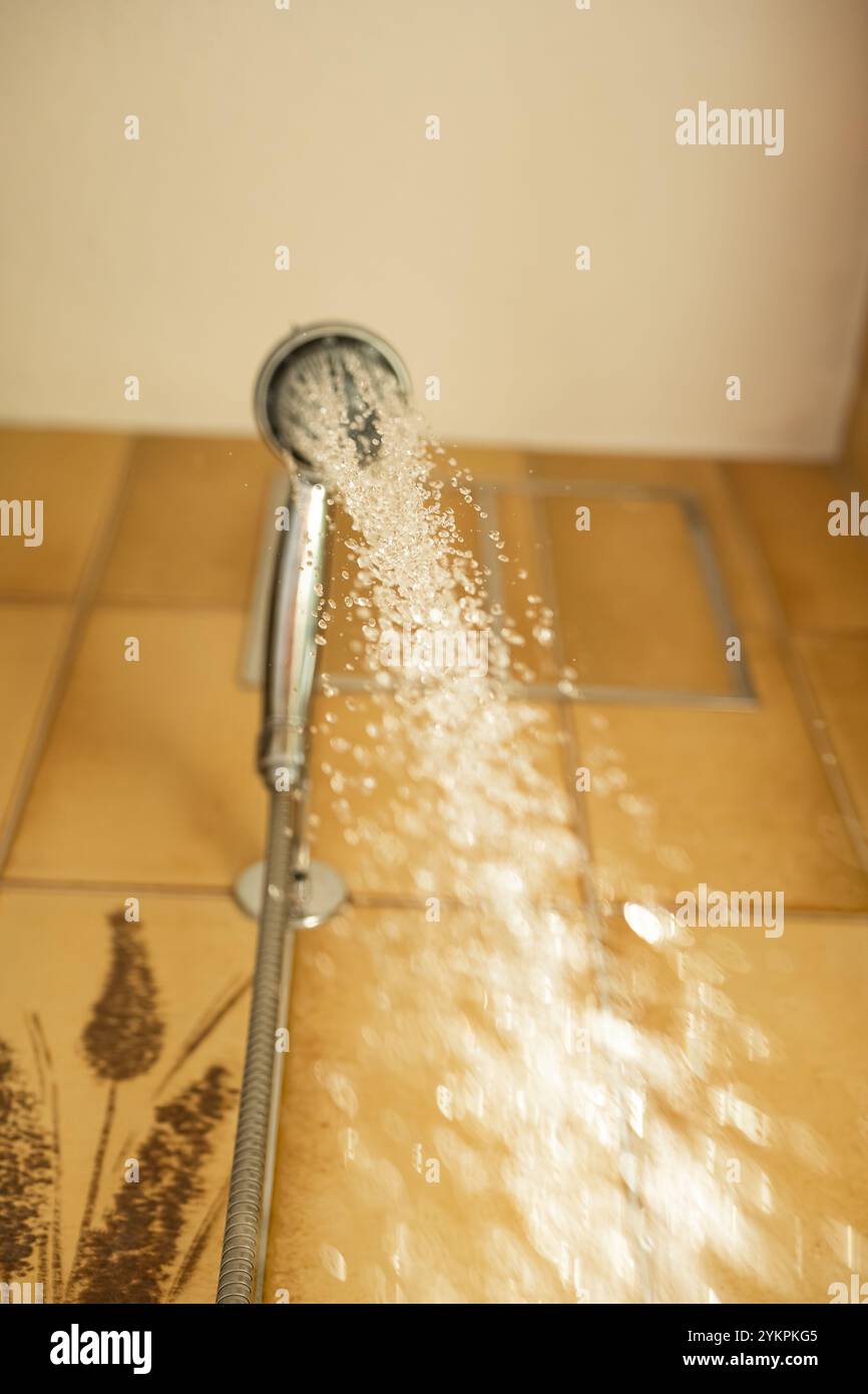 Shower head with running water. High shutter speed capture of water ...