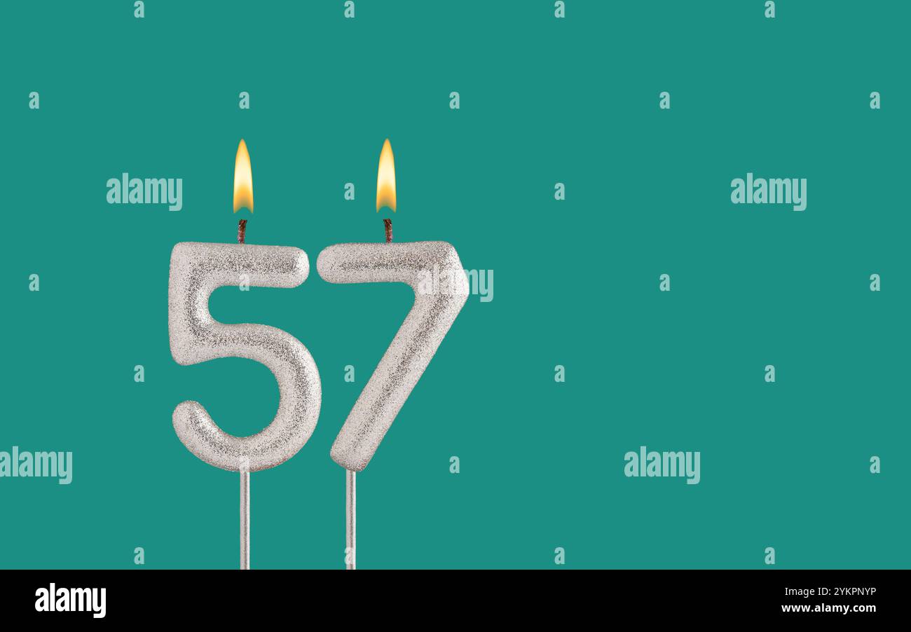 Birthday candle number 57 - Card on a green background Stock Photo - Alamy